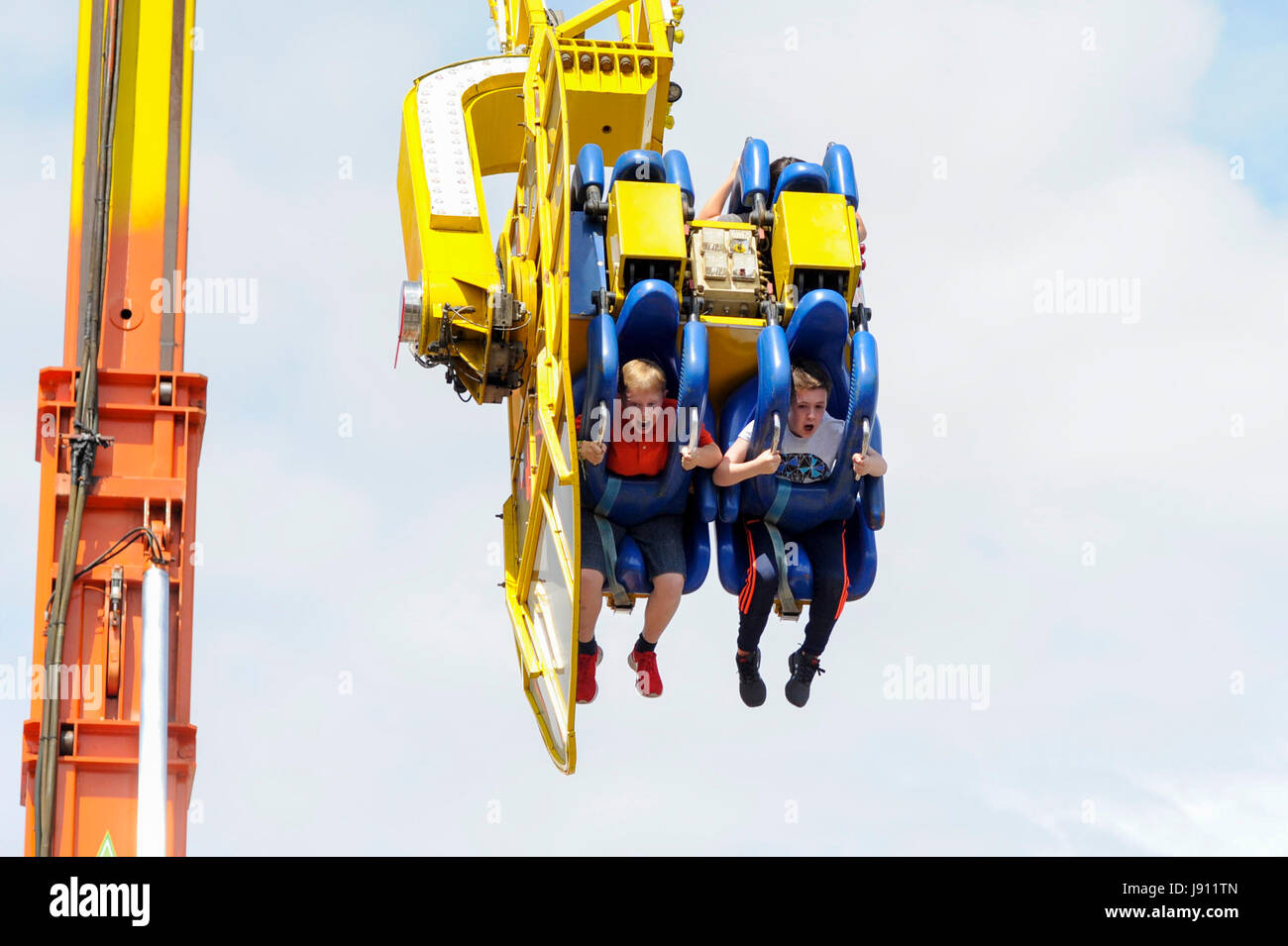London, UK. 31 May 2017. Customers fly overhead on a spinning ride ...