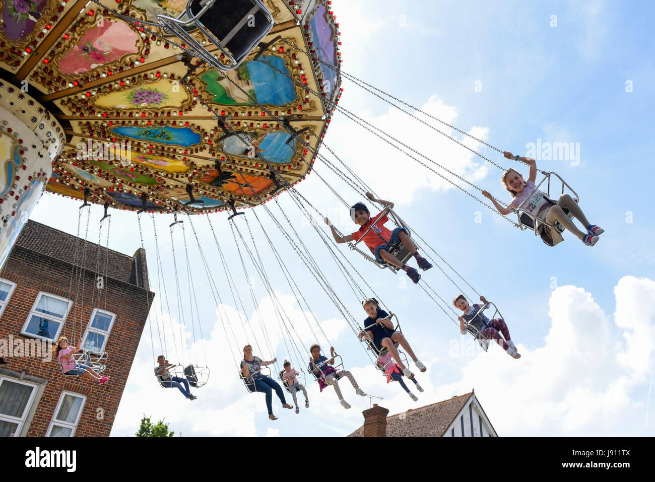 London, UK. 31 May 2017. Customers fly overhead on a spinning ride ...