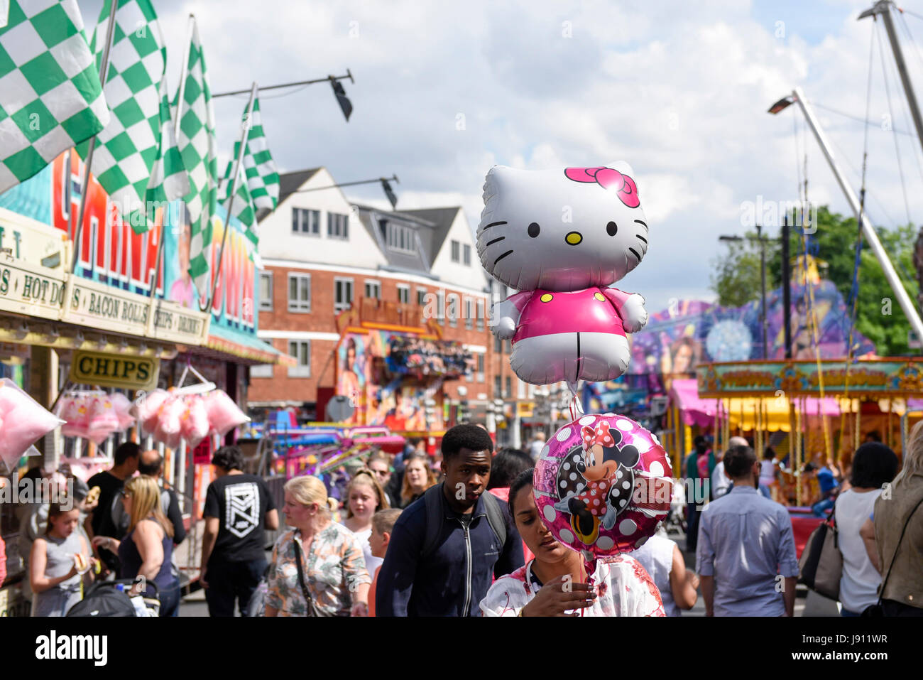 London, UK. 31 May 2017. A woman carries a Hello Kitty balloon ...
