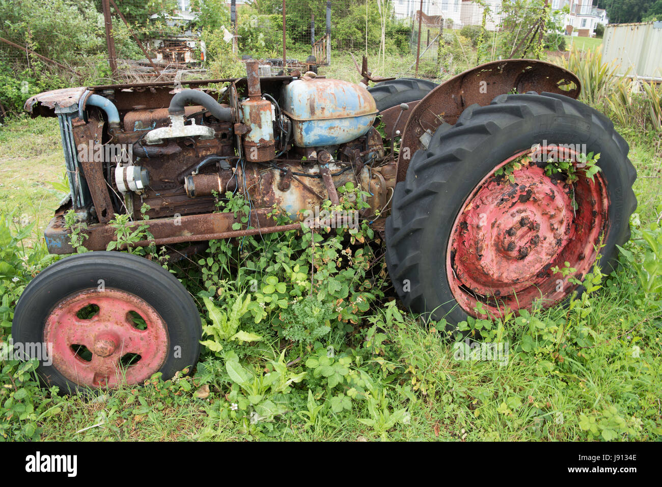 Old abandoned tractor rotting away Stock Photo - Alamy