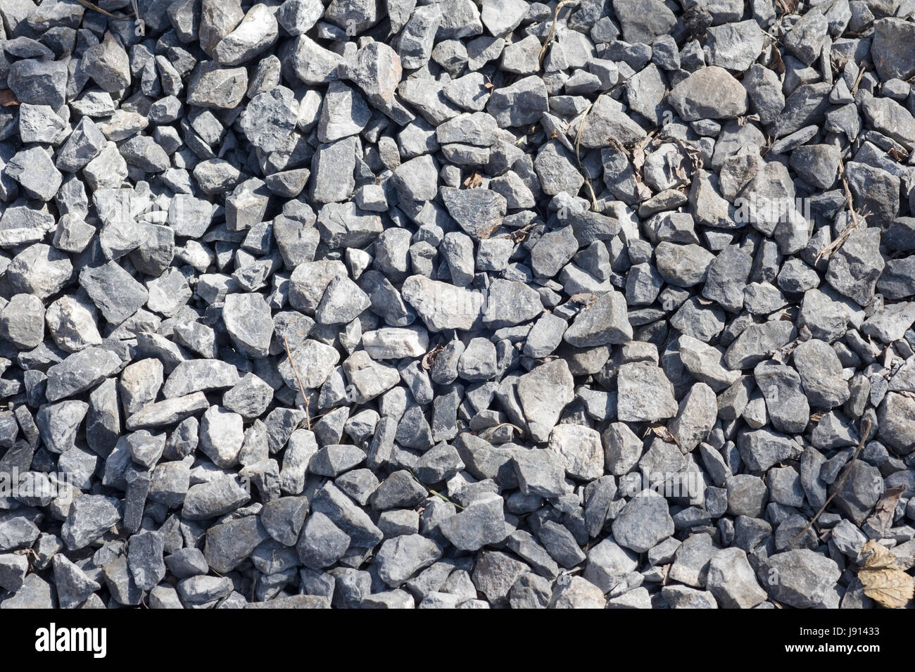 Small crushed stone on the road. Industrial bacjground Stock Photo - Alamy