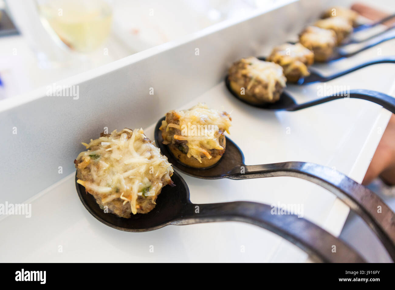 Spoons with mushrooms stuffed with gormet cheese, gormet dish Stock ...
