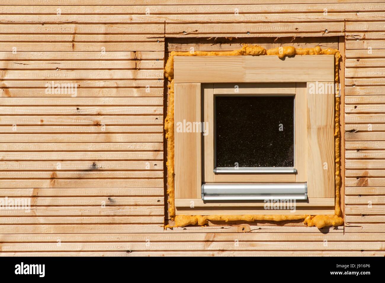 Wooden window. Foam window insulation on wooden construction. Building ...