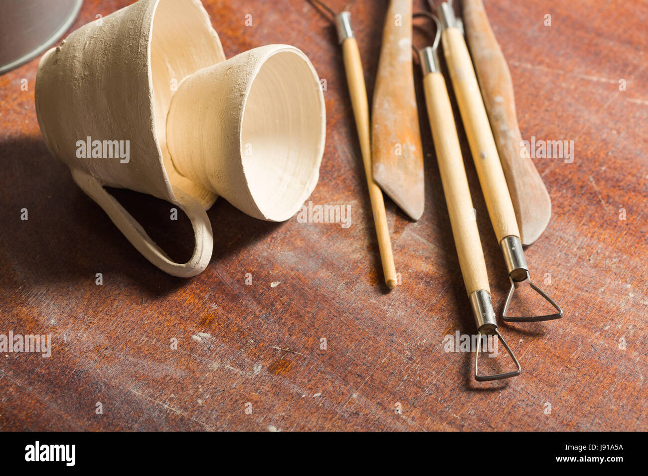 pottery, workshop, ceramics art concept - close-up on two unfired clay ...