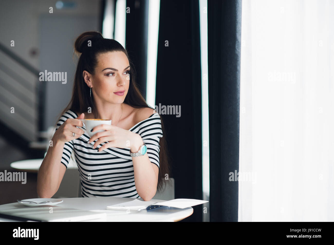Woman gazing through window hi-res stock photography and images - Alamy
