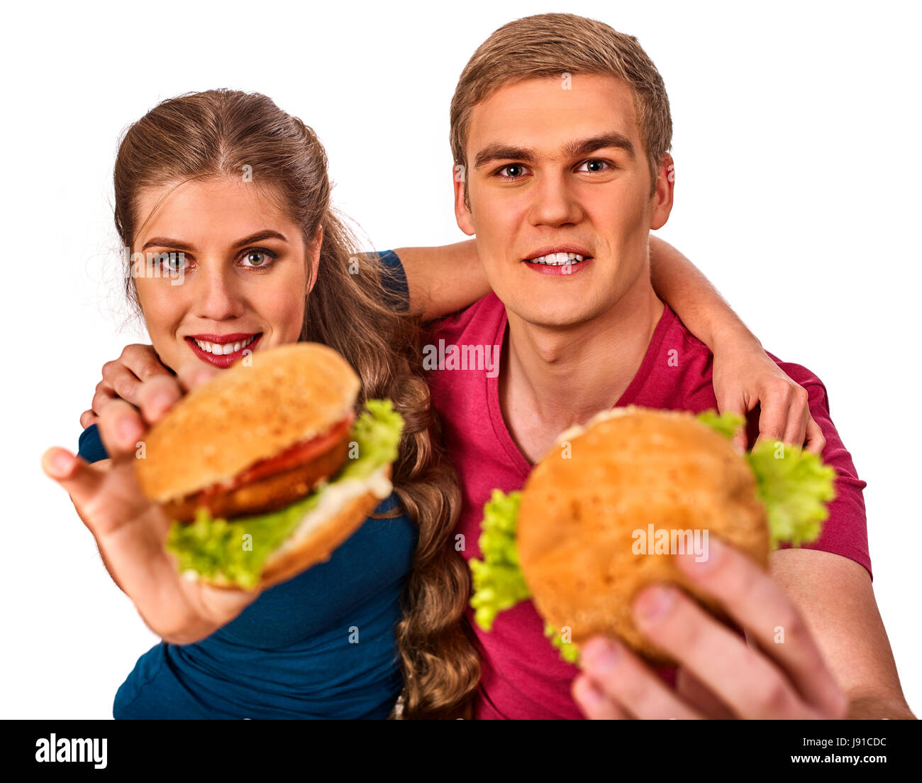 Couple eating fast food. Man and woman treat hamburger Stock Photo - Alamy