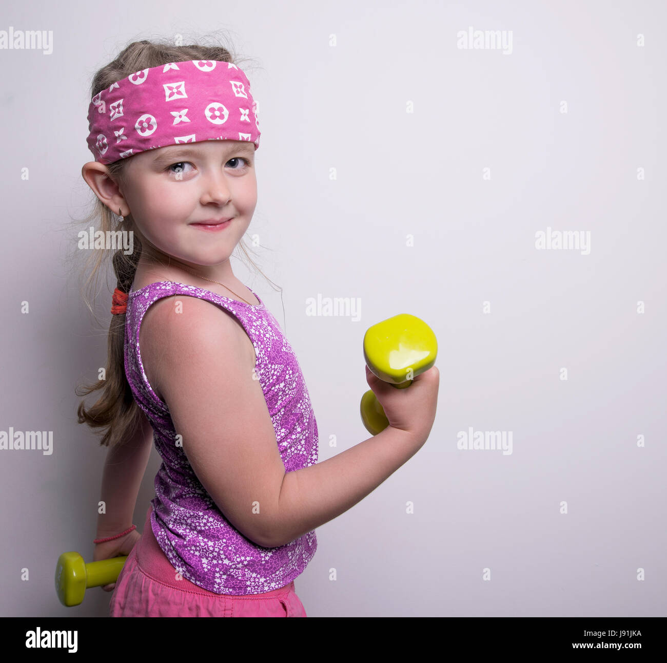cheerful athlete with dumbbells Stock Photo - Alamy