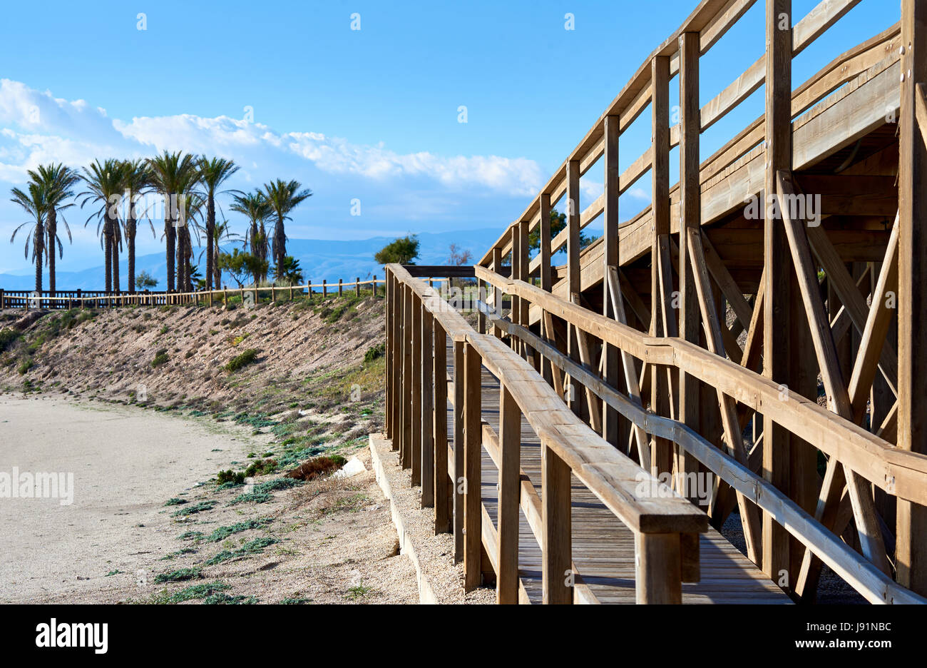 Wooden boardwalk leading to the Retamar beach. Almeria province, Spain ...