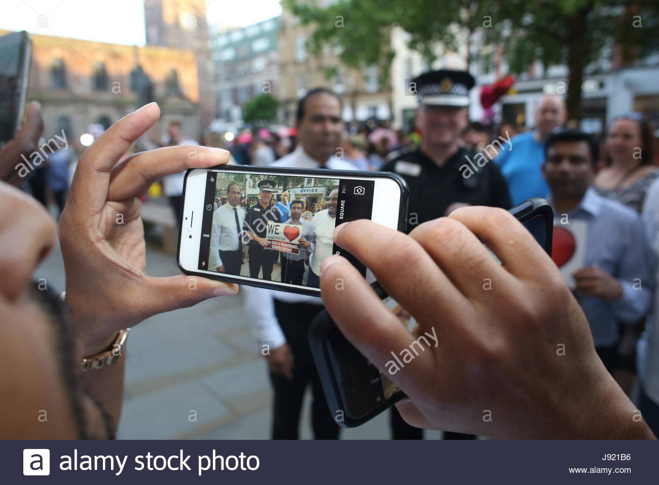 A member of the public photographs Police Chief Ian Hopkins and others ...