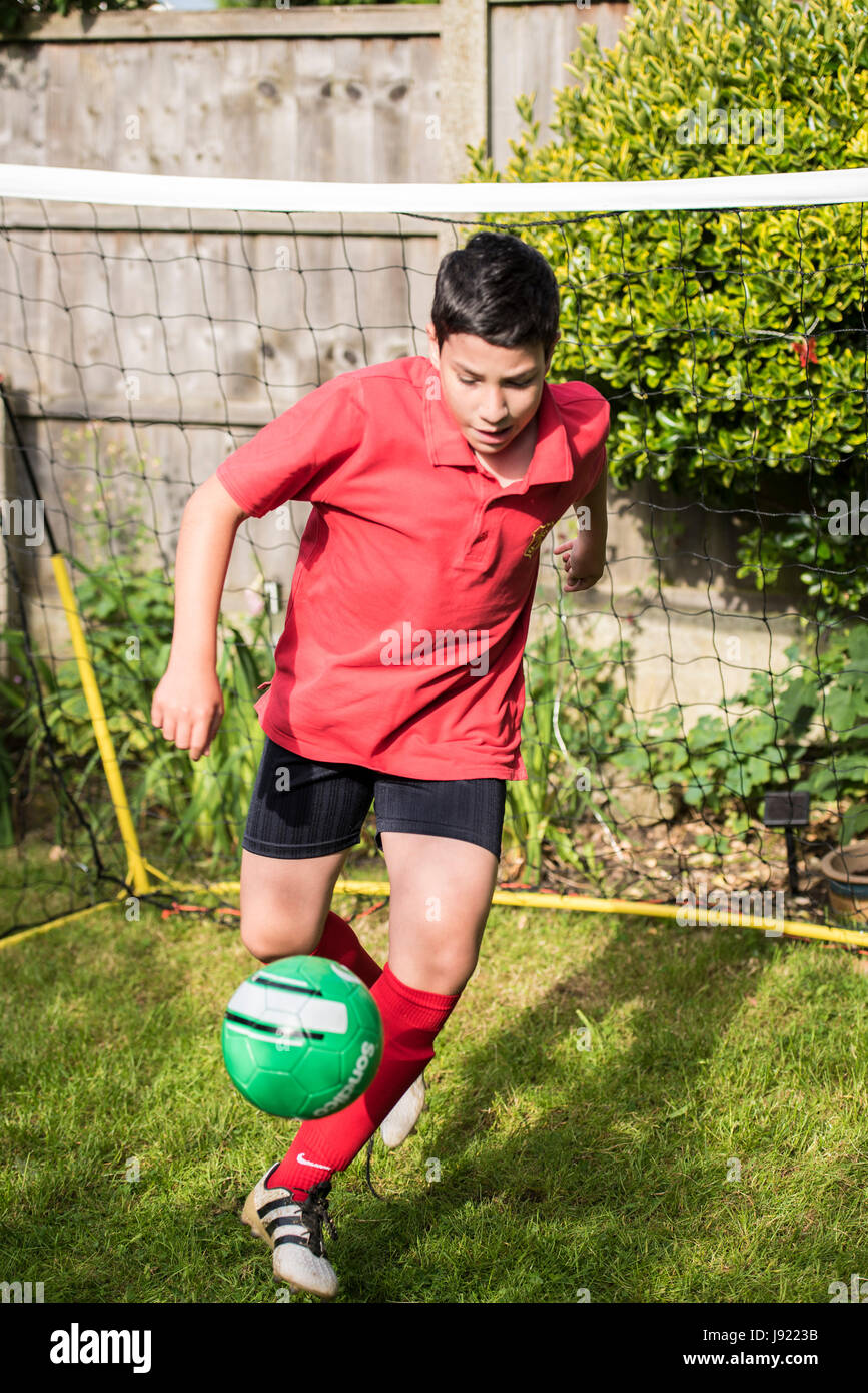 Kids playing soccer garden 9 hi-res stock photography and images - Alamy