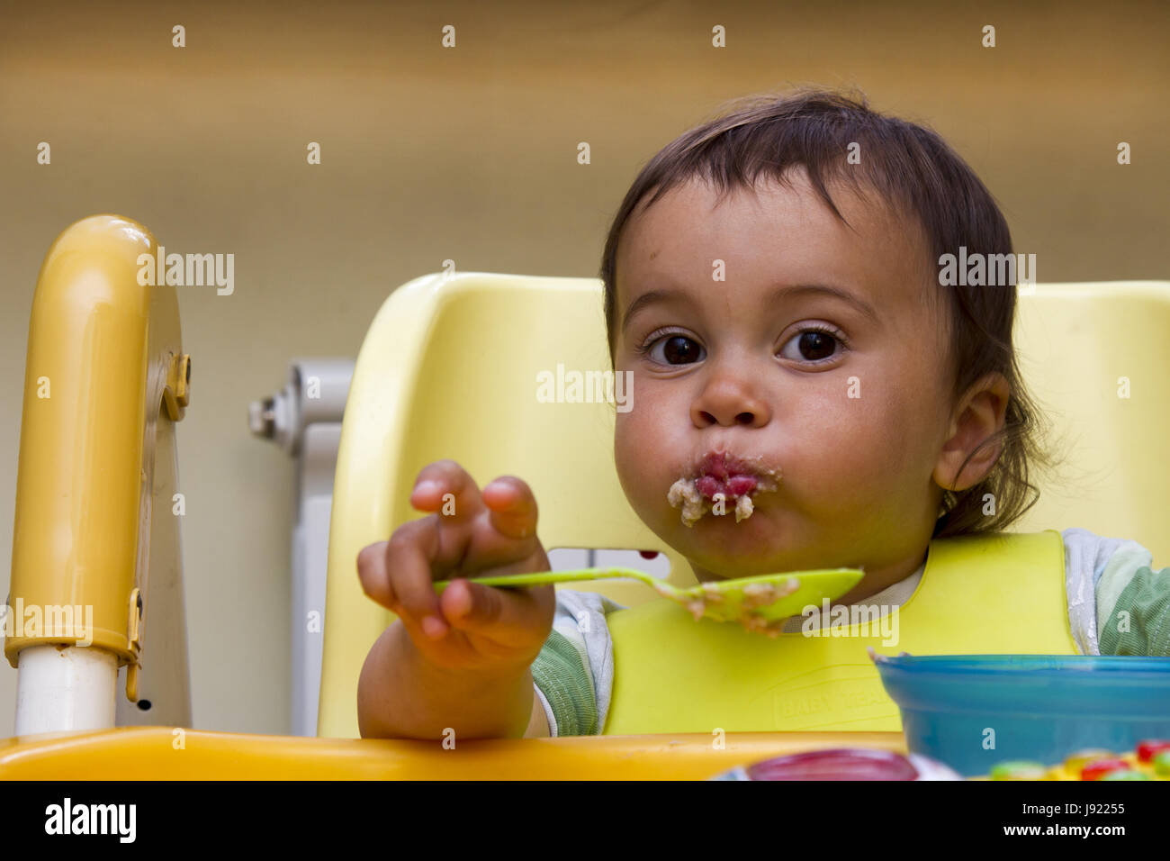 baby eating food on kitchen Stock Photo - Alamy