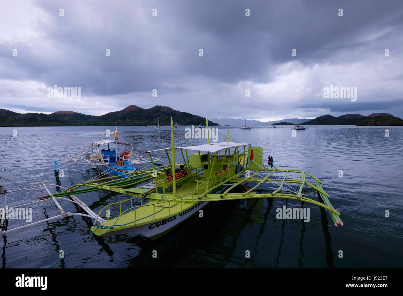 A traditional Bangka outrigger boat anchored in the town of Coron in ...