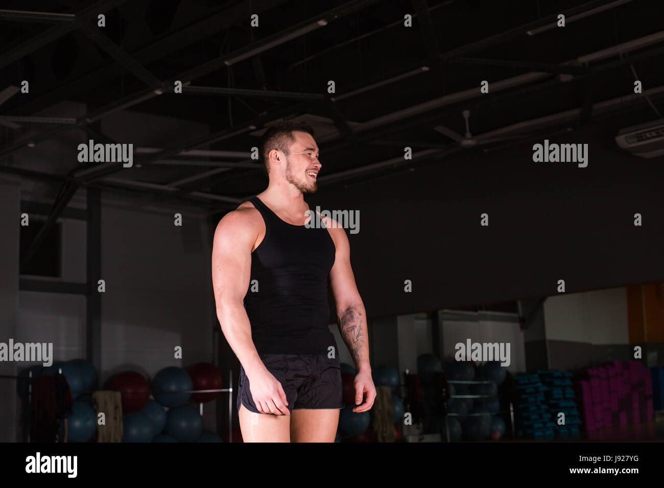 handsome fitness man weightlifting after workout in gym Stock Photo - Alamy