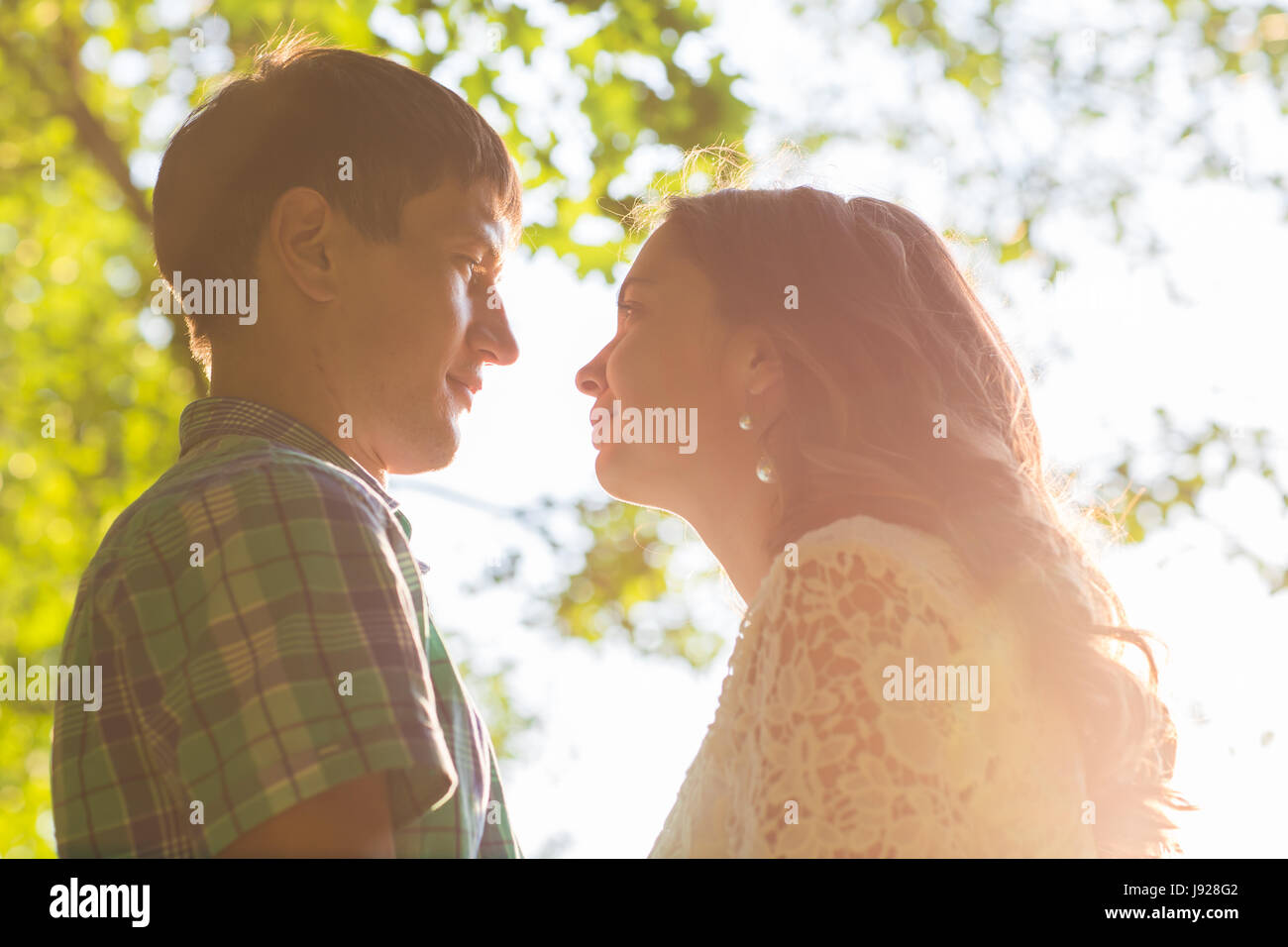 Closeup photo of romantic couple outdoors, side view Stock Photo - Alamy