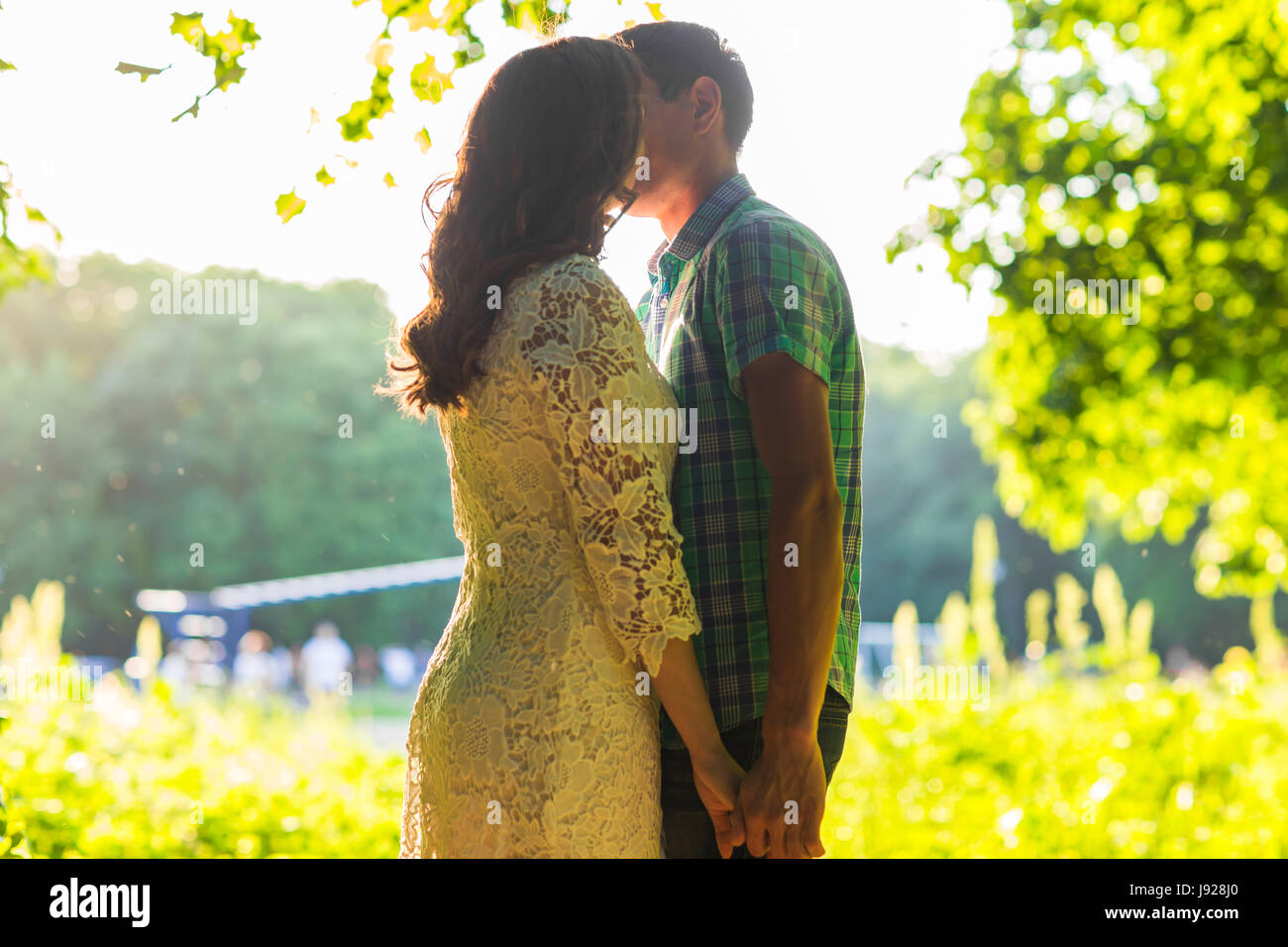 Closeup photo of romantic kissing couple outdoors, side view Stock ...