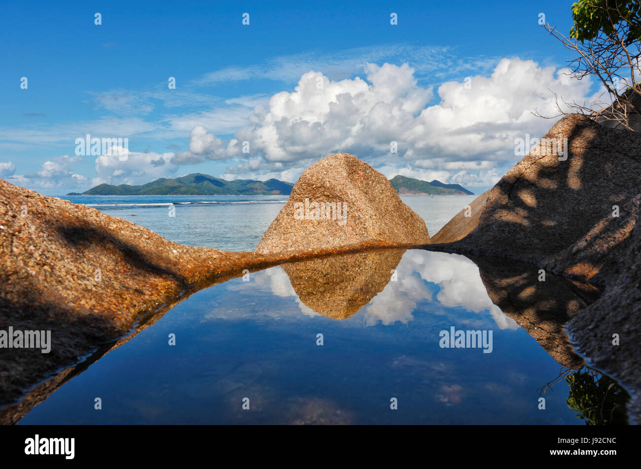 Water reflection of granite rocks on Seychelles island Stock Photo - Alamy