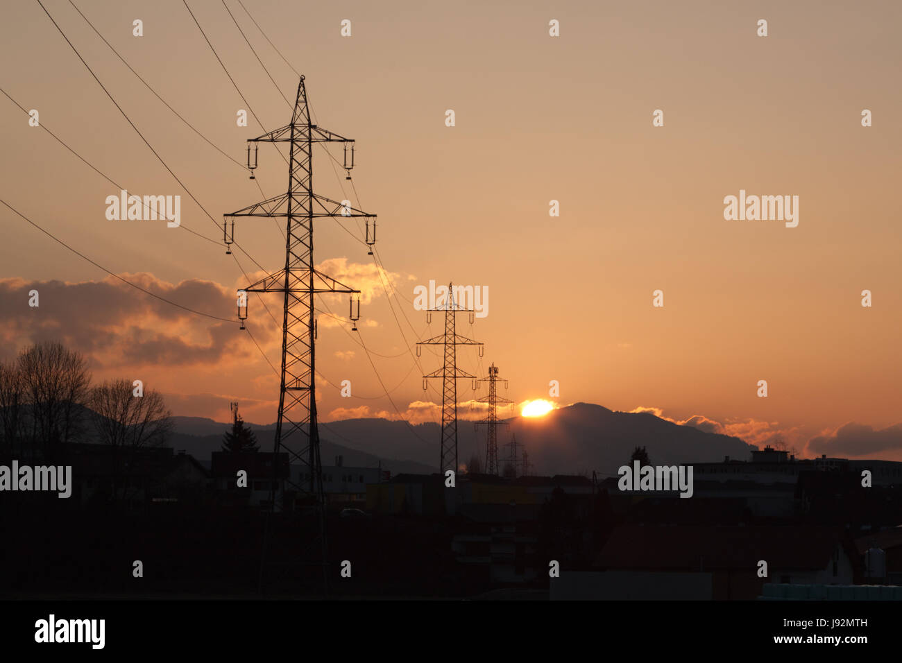 electricity pylons in the sunset Stock Photo - Alamy