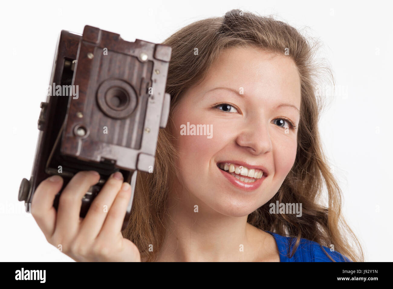 smiling woman showing old camera Stock Photo - Alamy