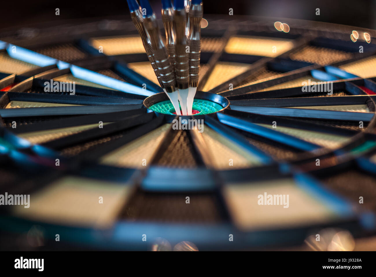 Three darts in the center of a dartboard target close up Stock Photo ...