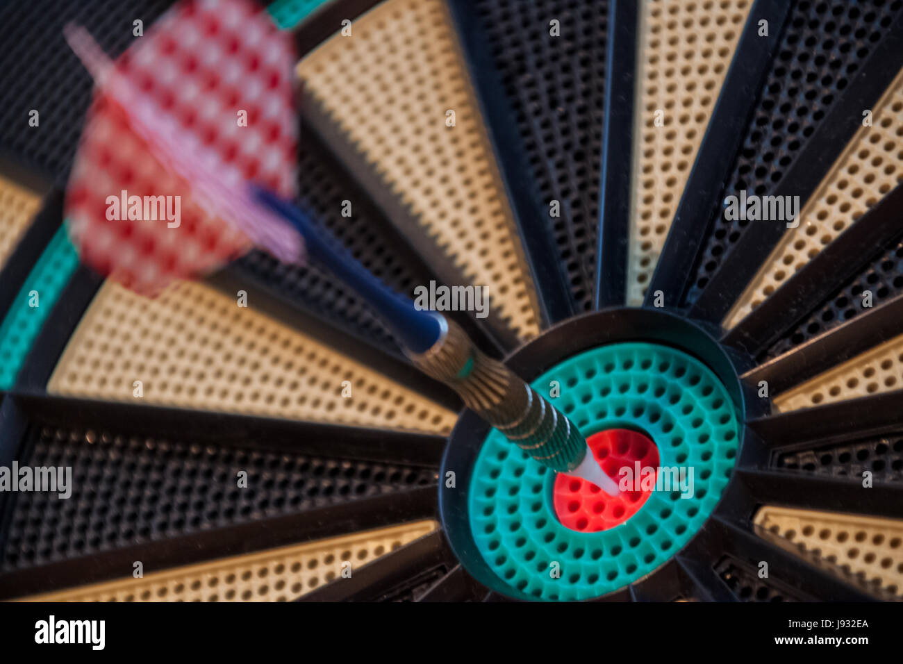 Colorful dart and target with green, yellow and red colors at the ...