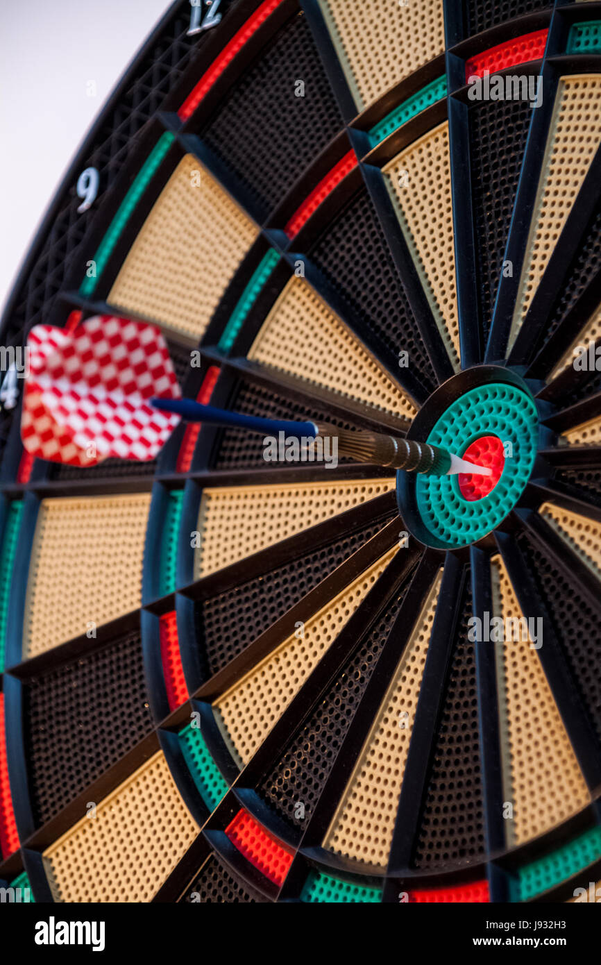 Colorful dart and target with green, yellow and red colors at the ...