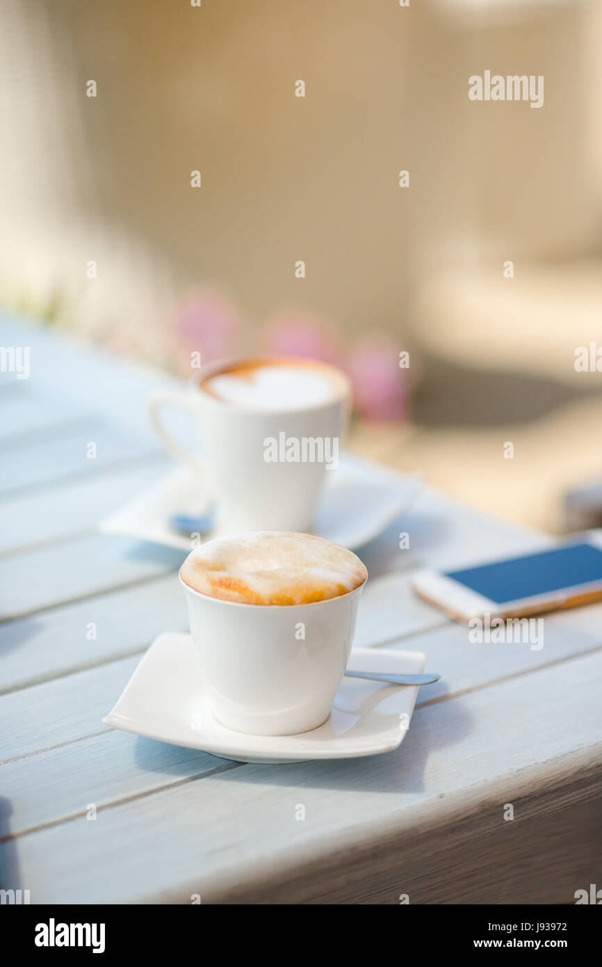 Some cup of coffee on table in restaraunt outdoor Stock Photo - Alamy