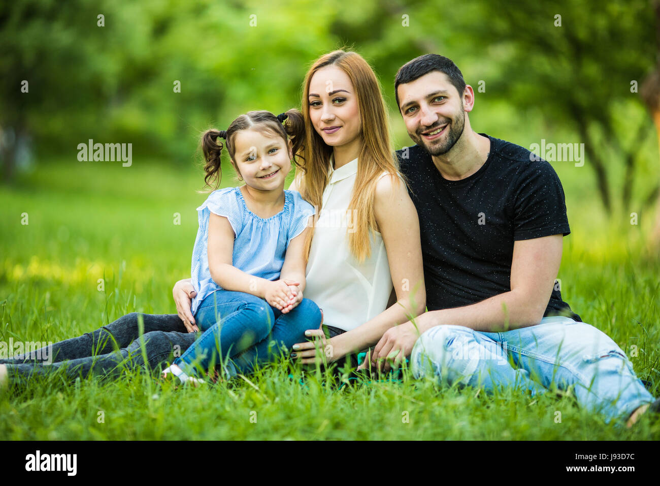 Family in green nature together in park Stock Photo - Alamy