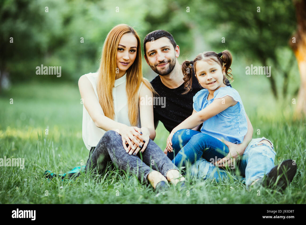 Family in green nature together in park Stock Photo - Alamy
