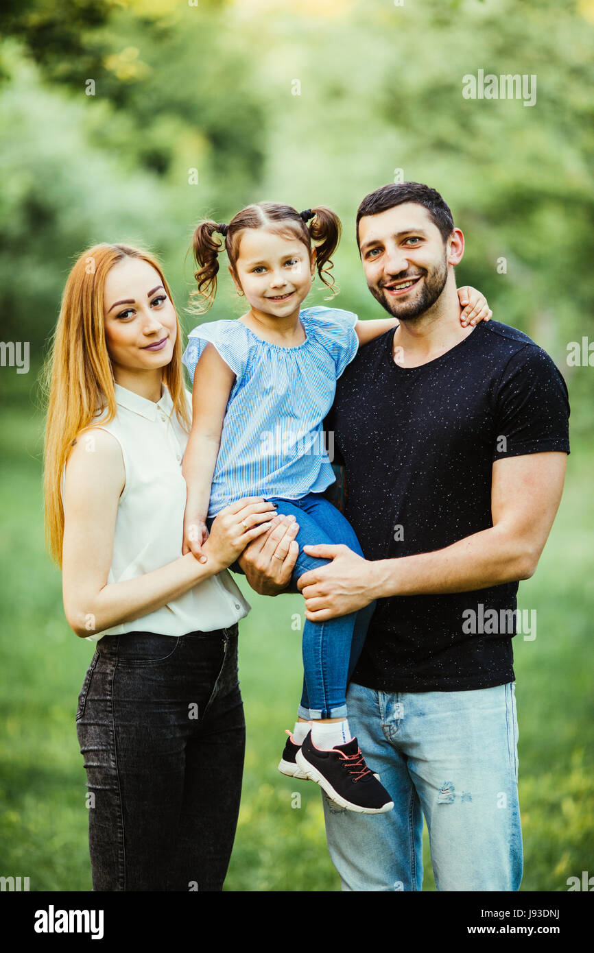 Happy mother, father and daughter in summer park Stock Photo - Alamy