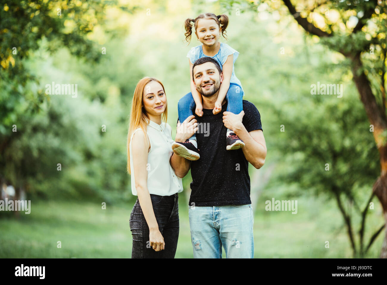 Happy mother, father and daughter in summer park Stock Photo - Alamy