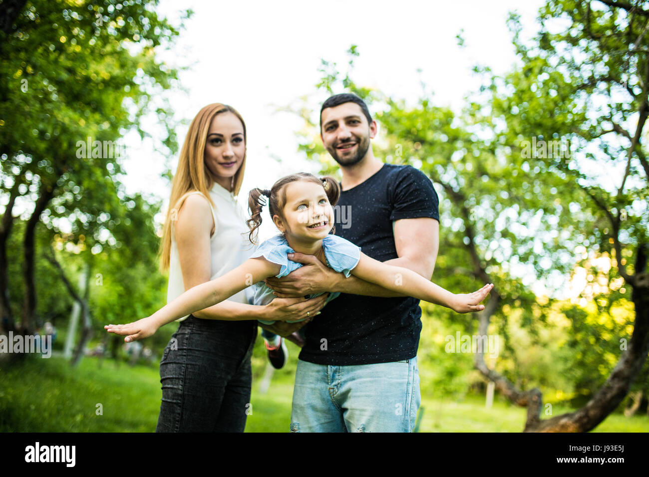 Happy mother, father and daughter in the park Stock Photo - Alamy