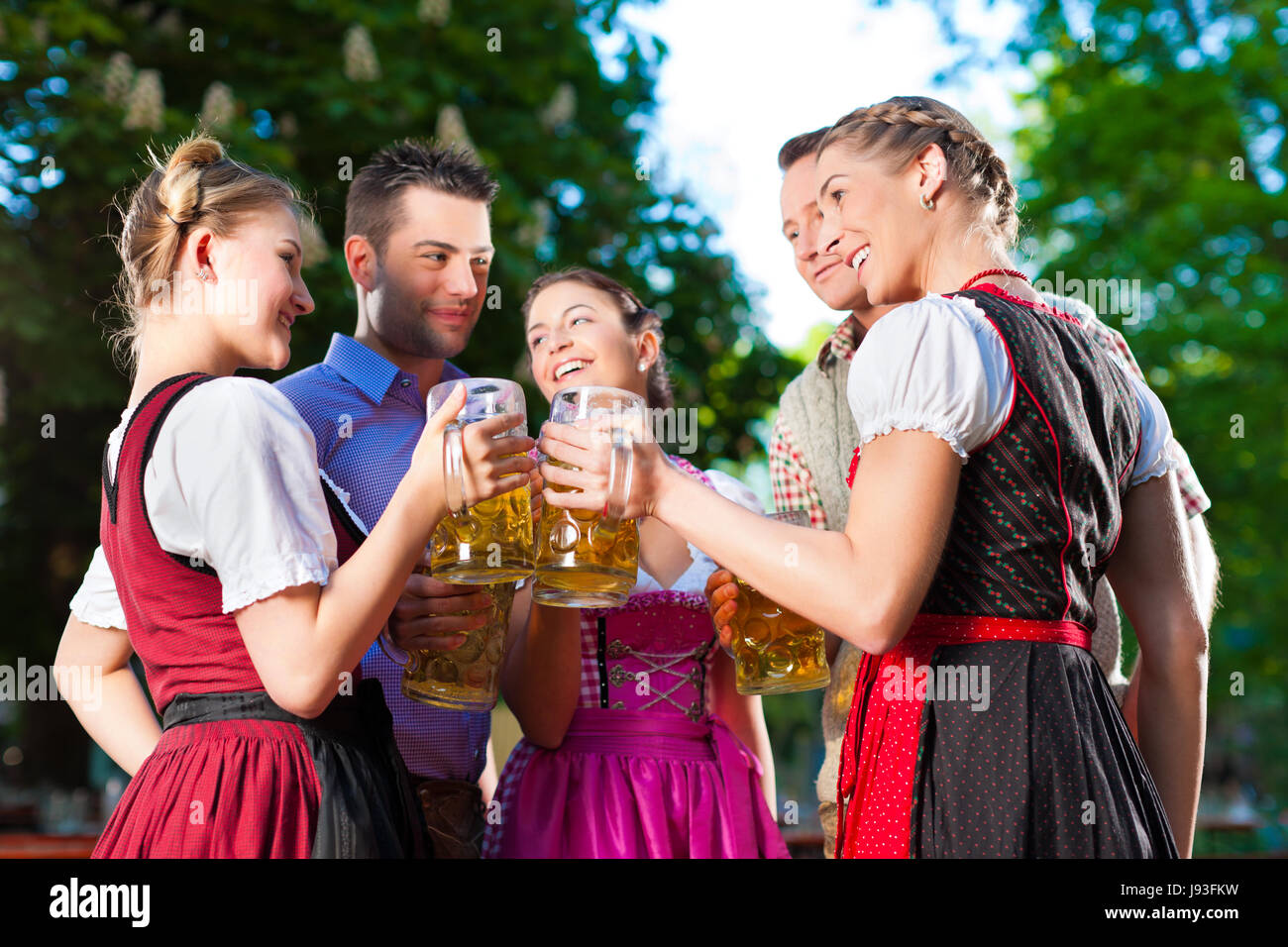 in beer garden - friends drinking beer Stock Photo - Alamy