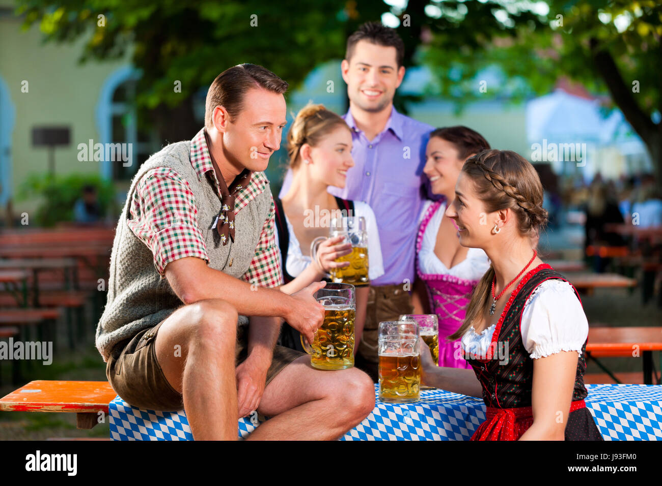 in beer garden - friends drinking beer Stock Photo - Alamy