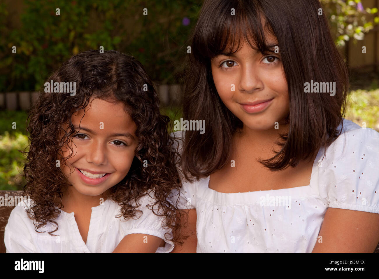 Hispanic sisters laughing and smiling outside Stock Photo - Alamy