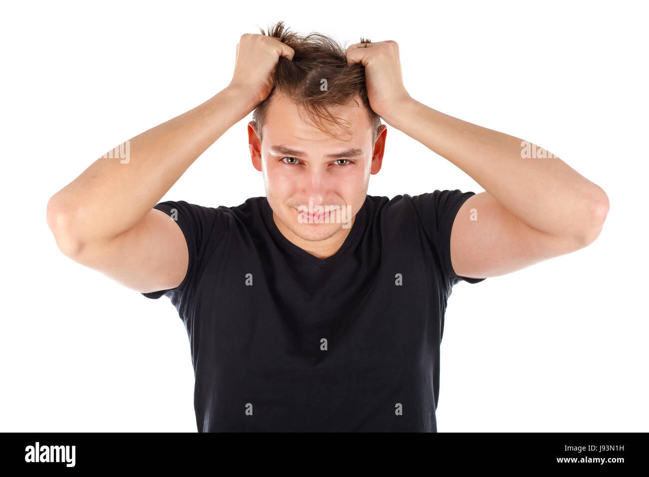 Picture of a nervous young man standing on an isolated background Stock ...