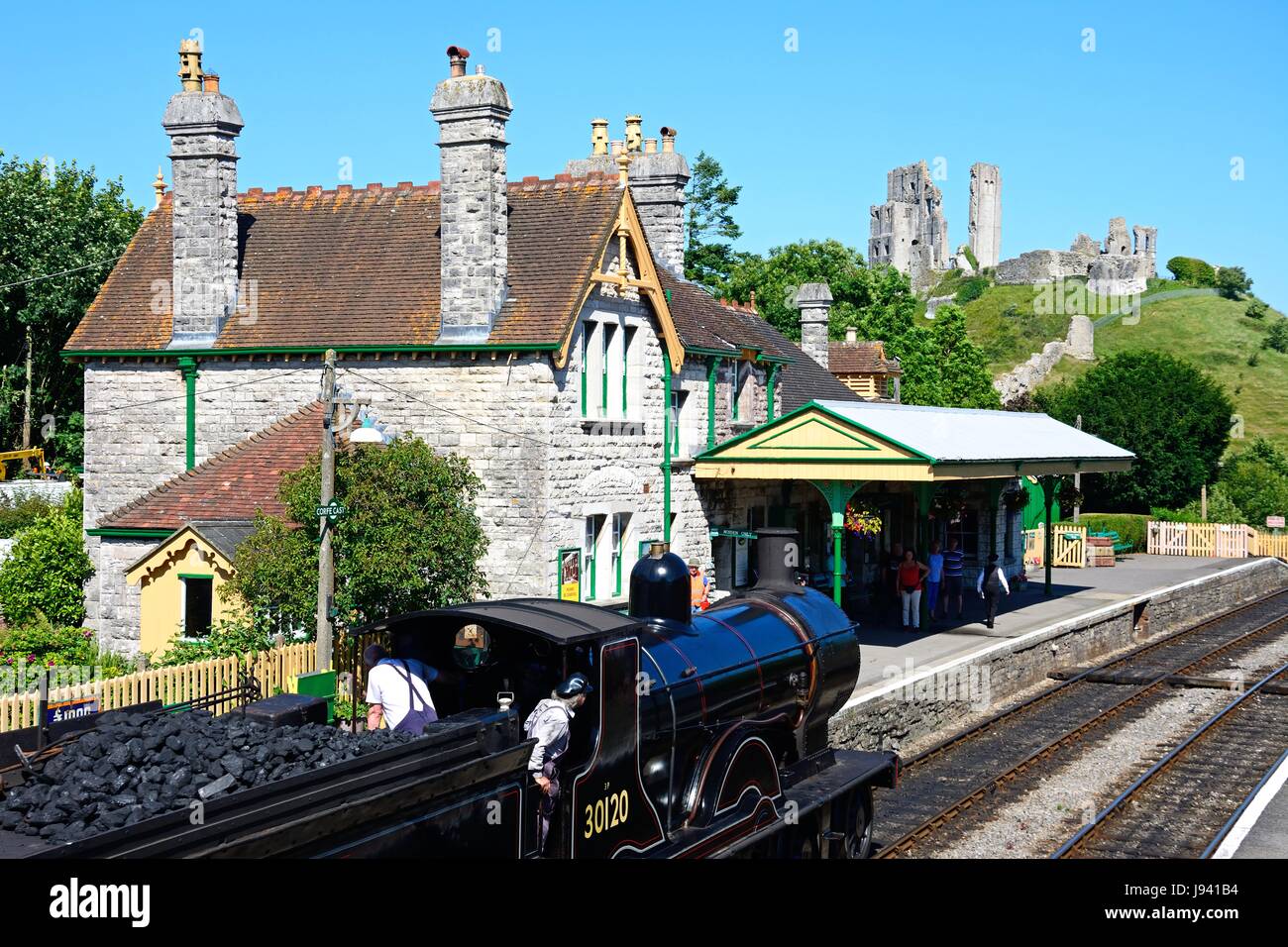 LSWR T9 Class 4-4-0 steam train entering the railway station with the ...