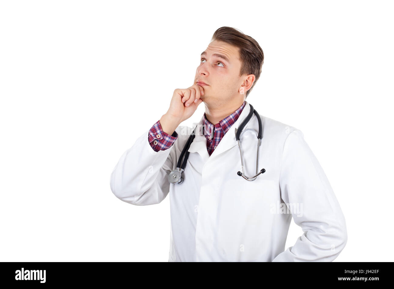 Picture of a handsome young doctor thinking about treatment Stock Photo ...