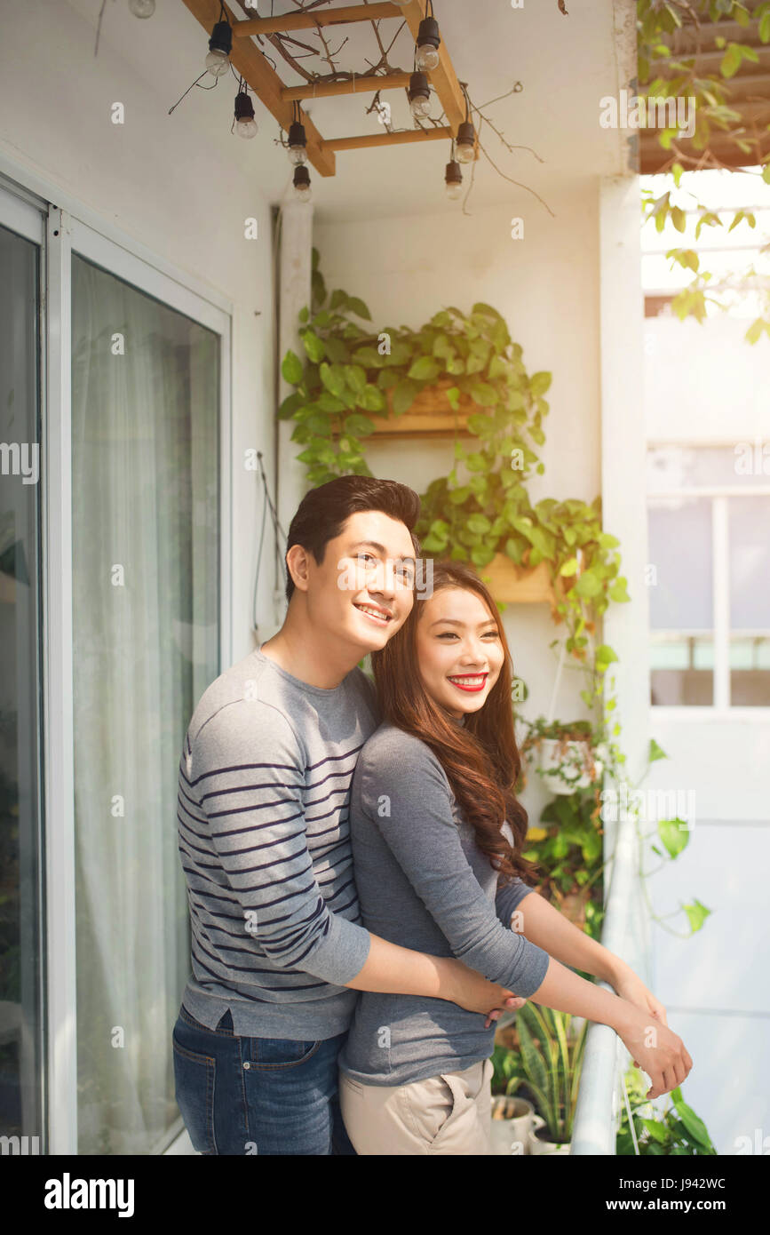Couple hugging on balcony hi-res stock photography and images - Alamy