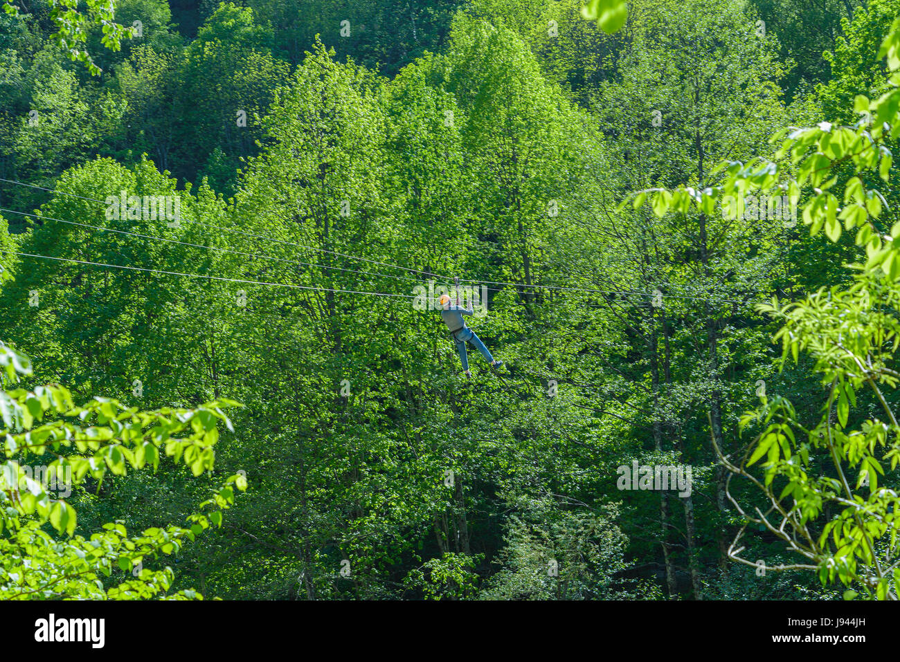 Tourist crossing a mountain gorge on a rope Stock Photo - Alamy
