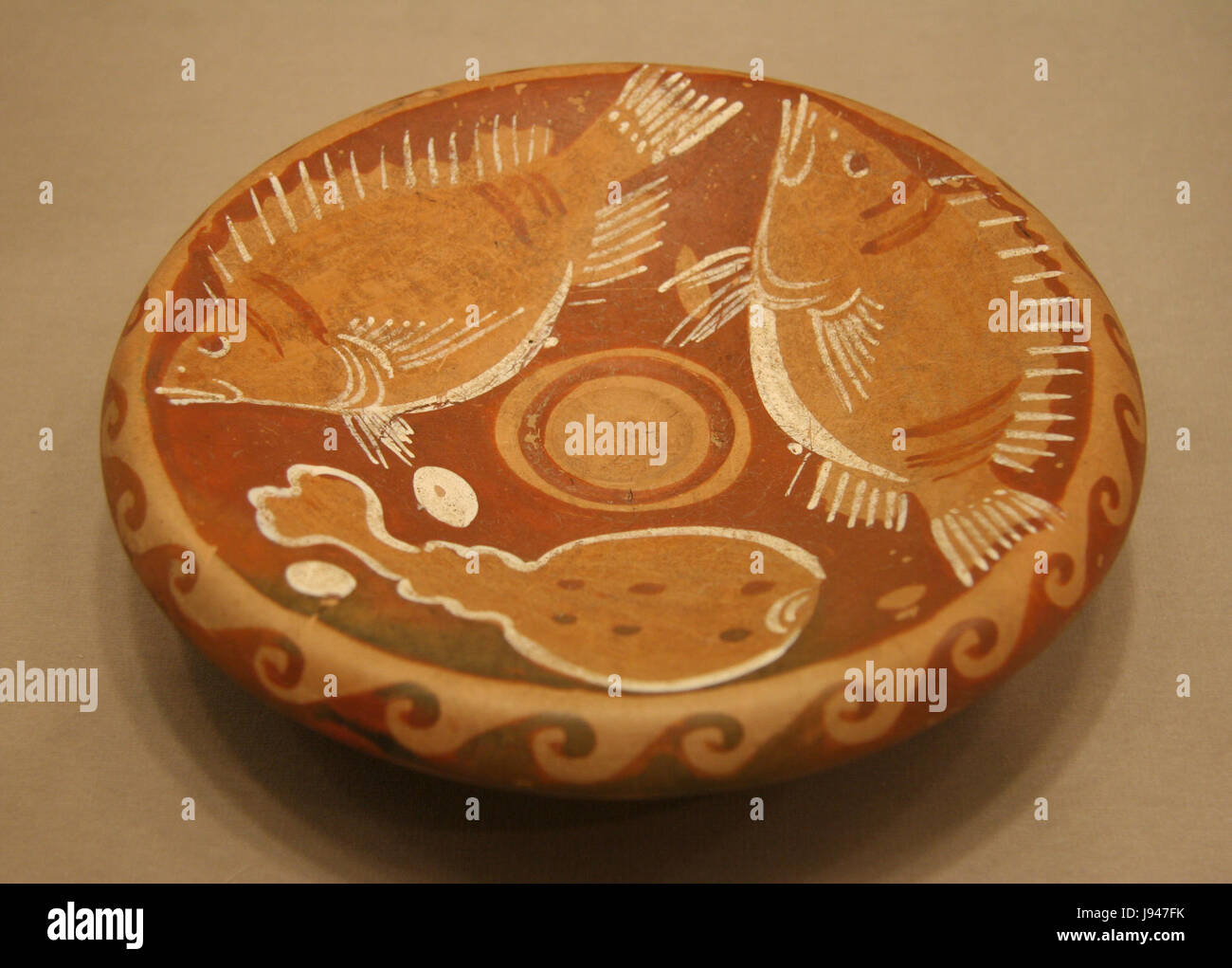 A terracotta plate, crafted from clay and often used in ancient and ...