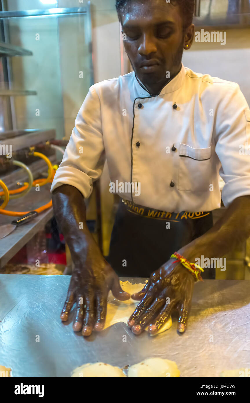 KANDY, SRI LANKA - NOVEMBER 28, 2016: The cook making traditional Sri ...