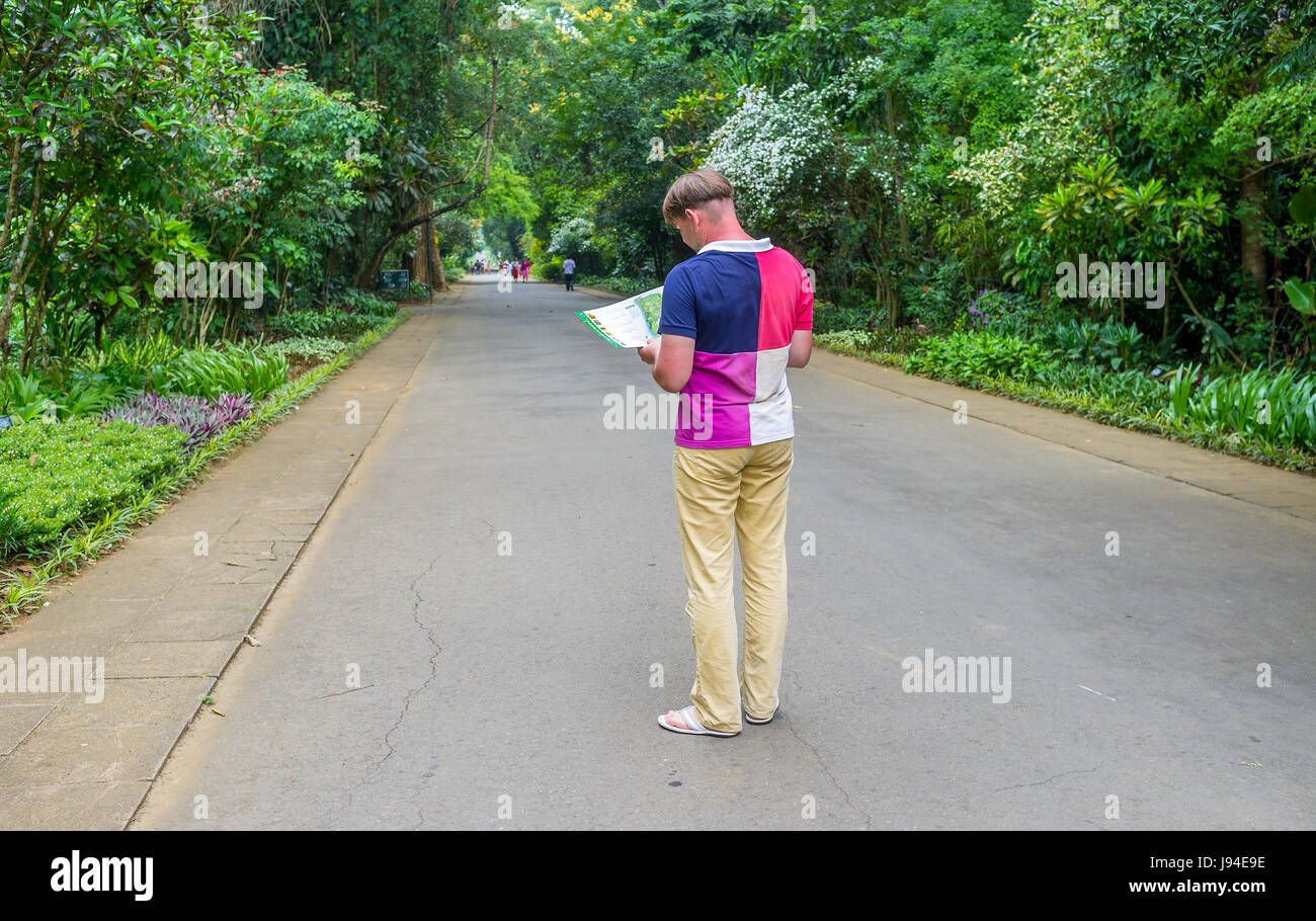 KANDY, SRI LANKA - NOVEMBER 28, 2016: The young man with a map of ...