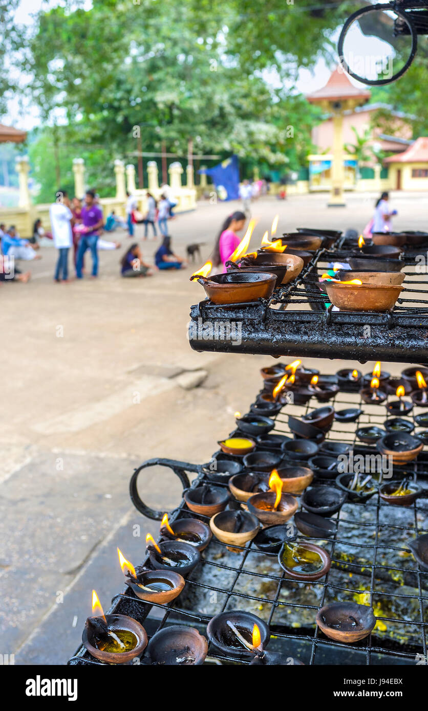 Buddha worshipers light candles as a sign of full enlightenment ...