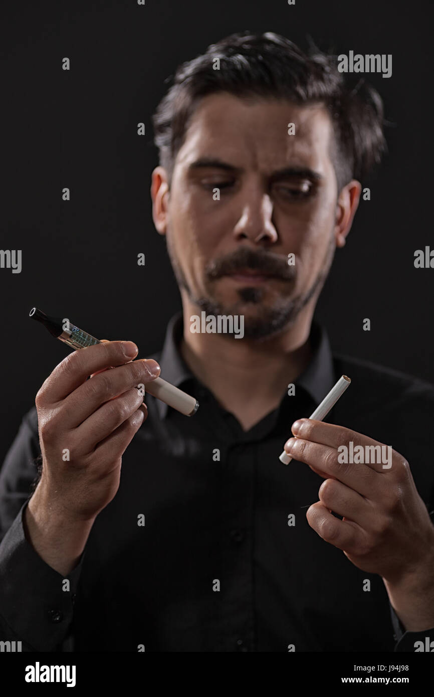 Portrait of man who is decided to quit smoking cigarette in favor of ...