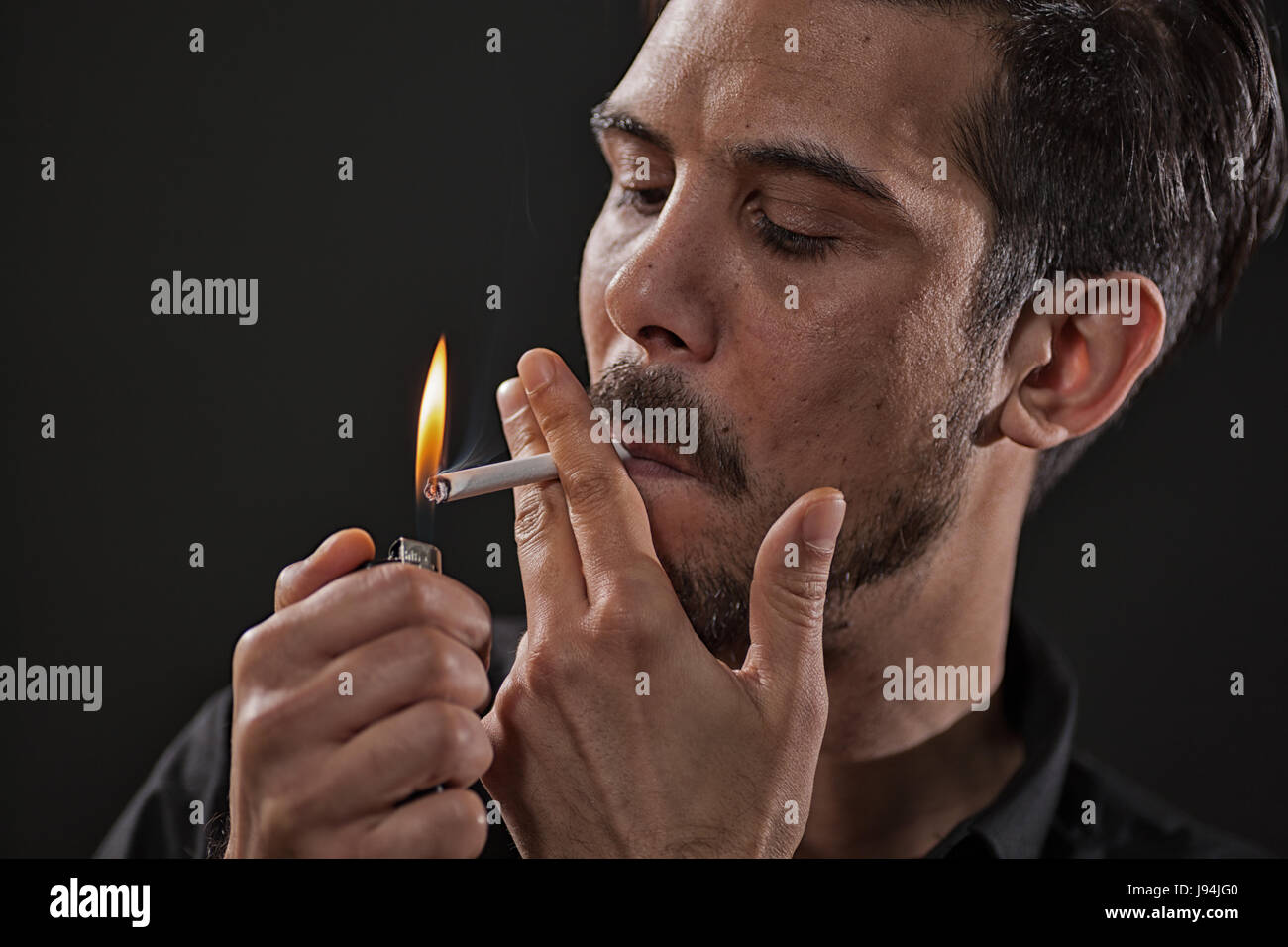 Portrait of adult man who is smoking cigarette Stock Photo - Alamy