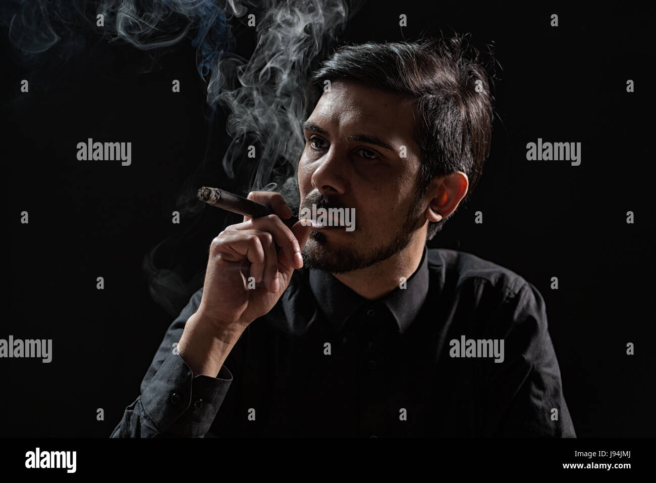Portrait of adult man who is smoking cigar Stock Photo - Alamy
