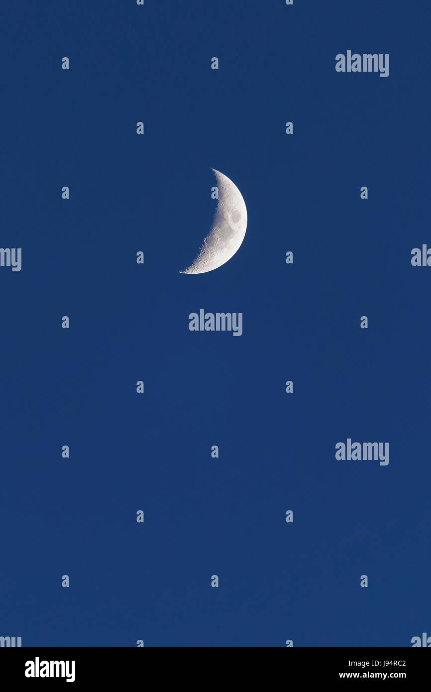 Waxing Crescent Phase of the Moon with Deep Blue Sky Stock Photo - Alamy