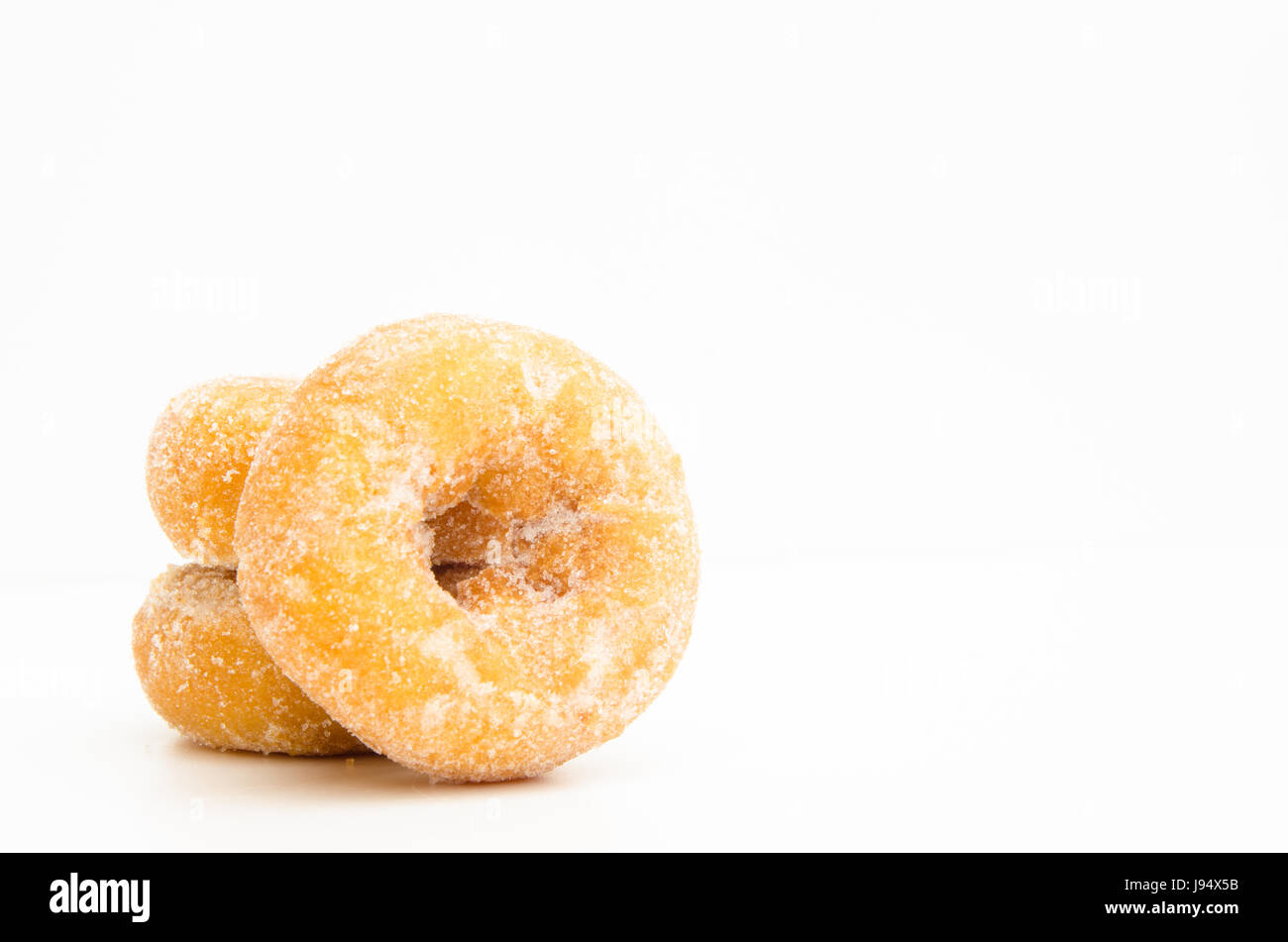 mini donuts sugar,sweet pieces of sugar doughnuts on white background ...