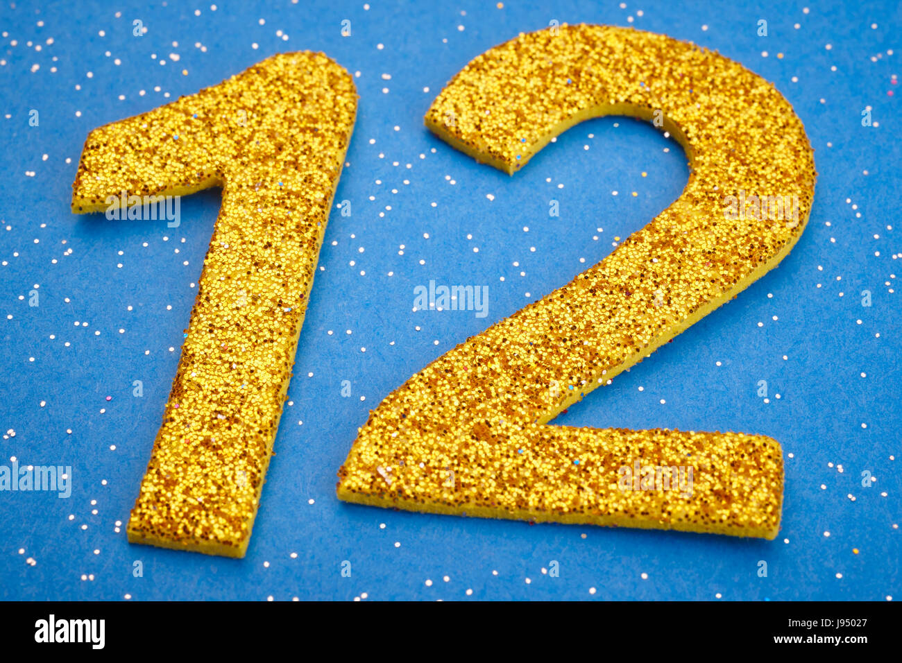 Number twelve yellow color over a blue background. Anniversary ...