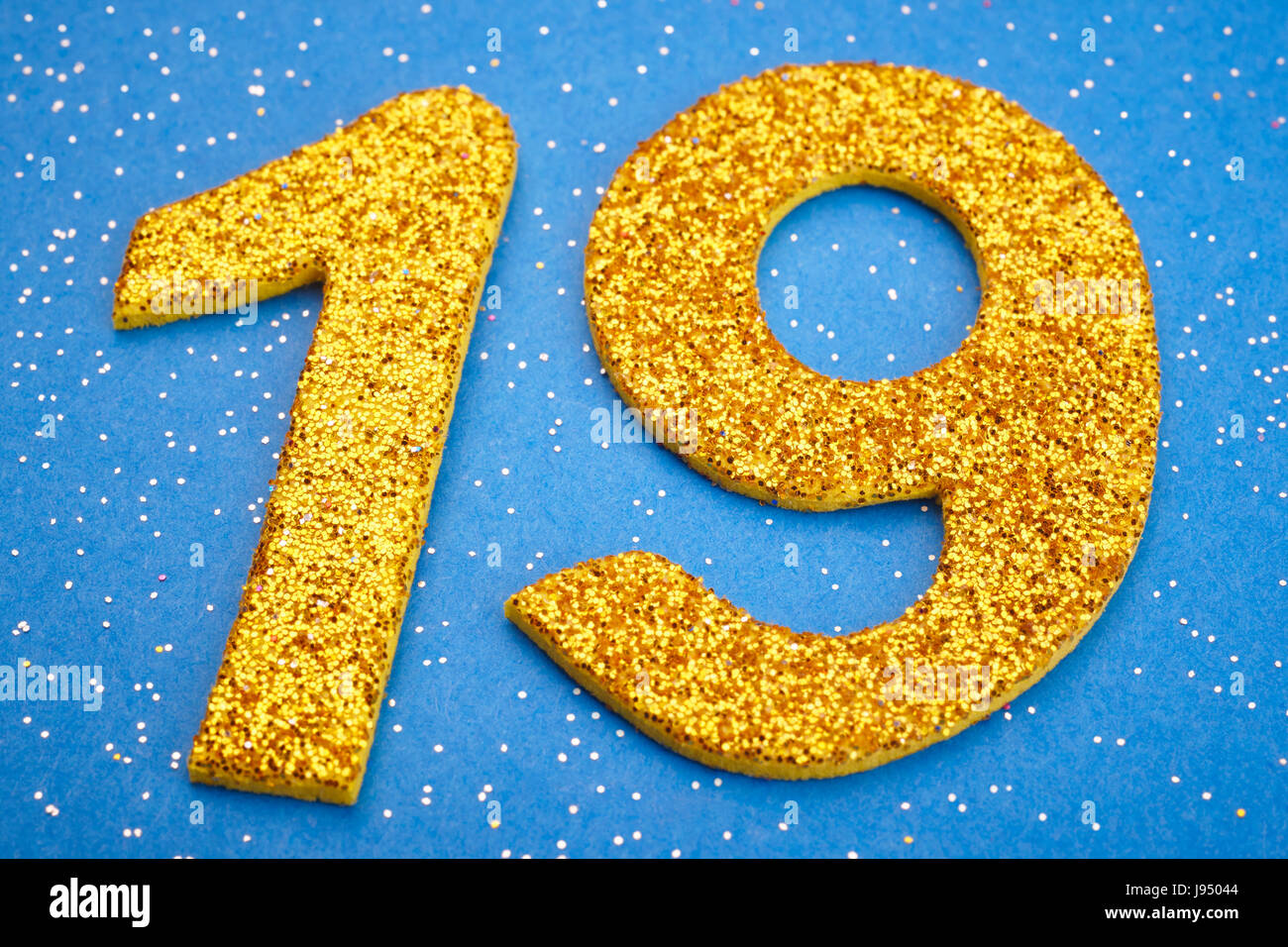 Number nineteen yellow color over a blue background. Anniversary ...